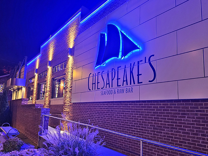 The blue neon sailboat sign beckons like a lighthouse for hungry travelers. Chesapeake's brick exterior promises seafood salvation in the heart of mountain country.