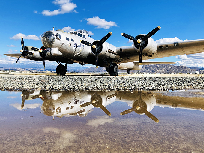 The gleaming B-17 "Flying Fortress" creates its own reflection pool, proving even 30,000-pound war machines can have their glamour shot moments.
