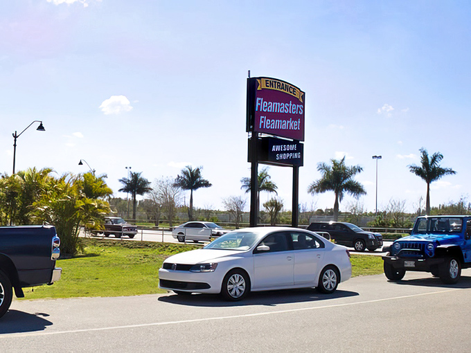 The iconic Fleamasters sign welcomes treasure hunters like a beacon of bargain possibilities. Florida palm trees frame this shopper's paradise perfectly.