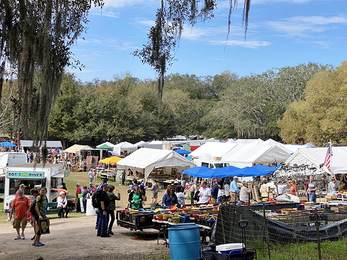 Spanish moss dangles like nature's bunting over this treasure hunter's paradise, where weekend warriors navigate rows of white tents in search of their next great find.
