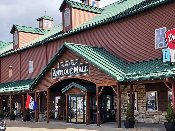The distinctive barn-red exterior with green roof makes Berlin Village Antique Mall stand out like a treasure chest waiting to be opened.