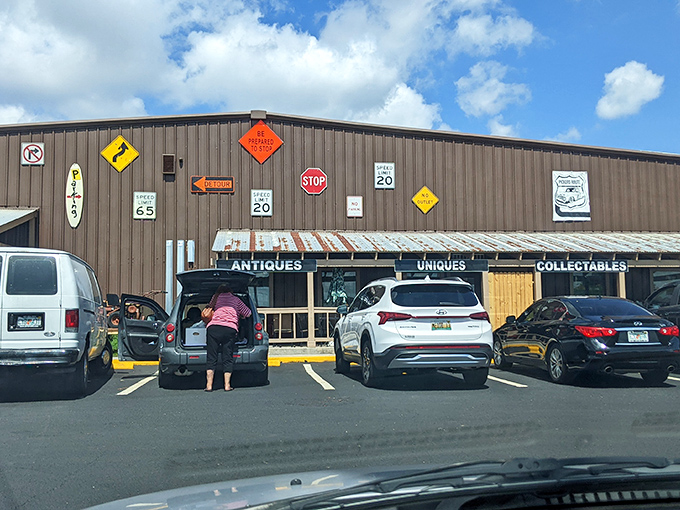 The unassuming exterior of Pickers Paradise belies the wonderland within. Vintage road signs hint at the time-traveling adventure awaiting treasure hunters inside.