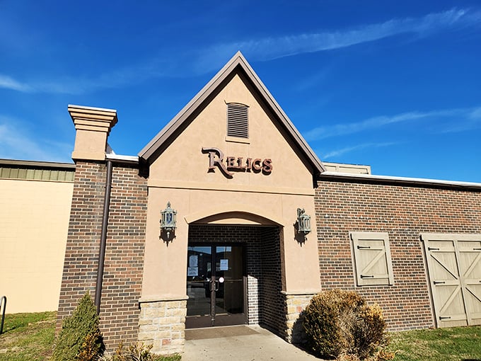The stately entrance to Relics beckons with its distinctive peaked roof and warm brick facade&mdash;a modest portal to an extraordinary world of vintage treasures within.