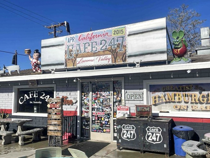 The unassuming exterior of Cafe 247 stands like a culinary mirage in the desert, complete with an alien mascot who clearly knows where the good food is.