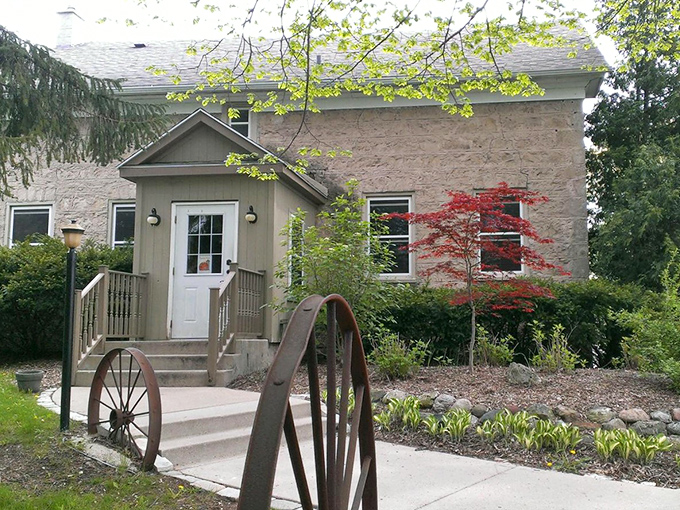 Stone walls and wagon wheels welcome you to The Farmstead, where rustic charm meets culinary excellence in Cedarburg's countryside.