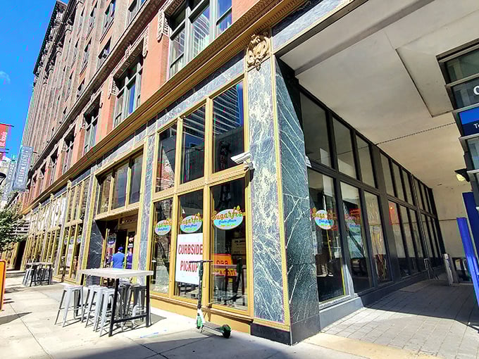 The golden-framed entrance to Sugarfire beckons like a portal to meat paradise. Those flames on the logo? A delicious warning of what's to come.