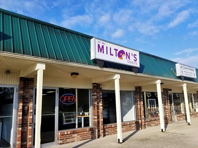 The unassuming storefront of Milton's Donuts, where culinary magic has been happening since 1960. Some architectural wonders hide behind green roofs and brick facades.