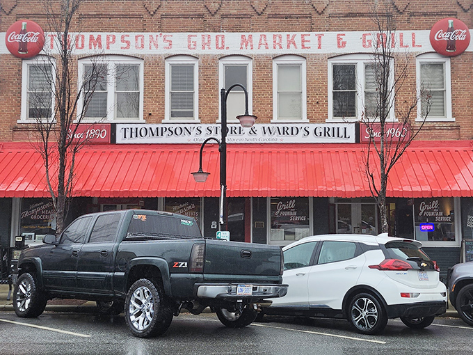 The iconic red awning of Thompson's Store & Ward's Grill beckons like a culinary lighthouse on Saluda's Main Street. Small-town charm, big-time flavor awaits. 
