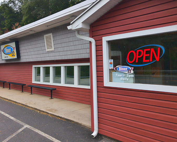 The iconic red exterior of Diner 22 beckons hungry travelers like a lighthouse for the breakfast-deprived. That neon "OPEN" sign might as well say "salvation ahead."