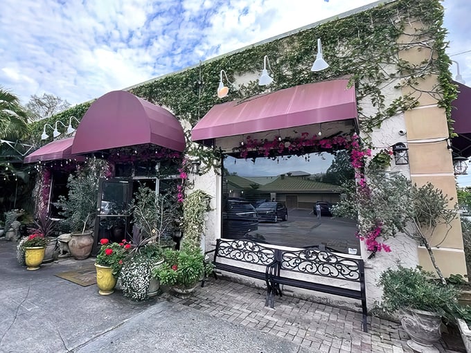 The entrance to pizza paradise! Cristino's charming exterior with its distinctive stone sign promises authentic Italian flavors that await just steps from Gulf-to-Bay Boulevard.
