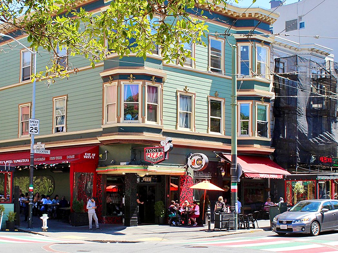 The mint-green Victorian with red awnings isn't just another pretty San Francisco facade—it's the gateway to pizza paradise that's worth every minute of the inevitable wait.