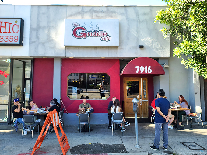 That unassuming red storefront holds breakfast secrets that would make your grandmother weep with joy. 