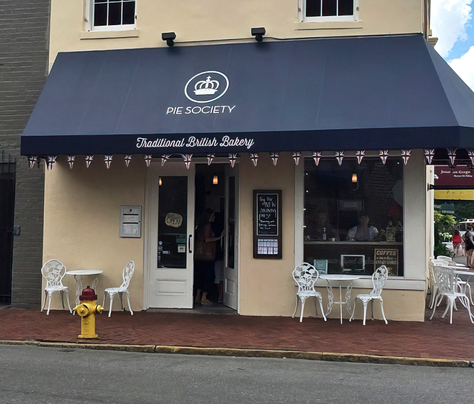 The navy blue awning of Pie Society beckons like a British flag in Savannah's historic district, promising proper pastries and afternoon tea.
