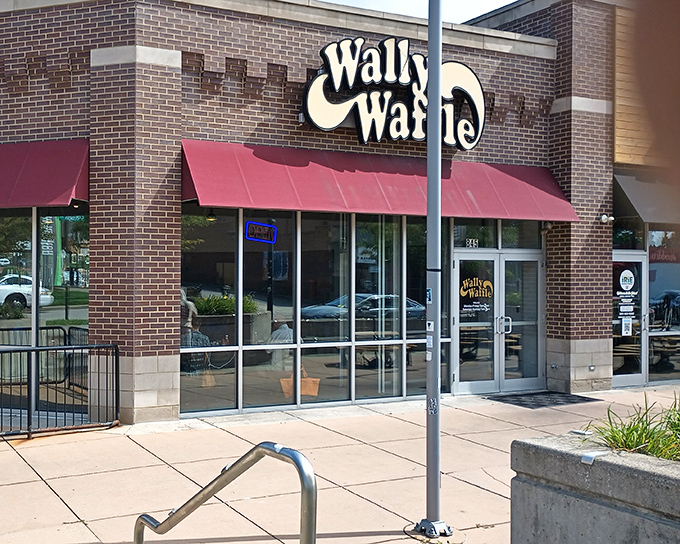 The iconic yellow Wally Waffle sign beckons breakfast enthusiasts like a lighthouse guiding hungry sailors to the shores of deliciousness.