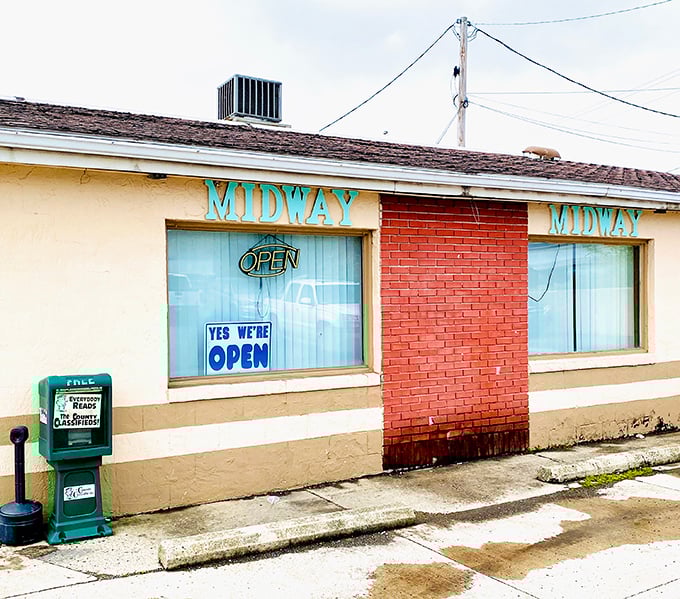 The unassuming exterior of Midway Restaurant stands as a beacon of honest cooking in Kenton, where the "YES WE'RE OPEN" sign might be the best news you'll get all day.