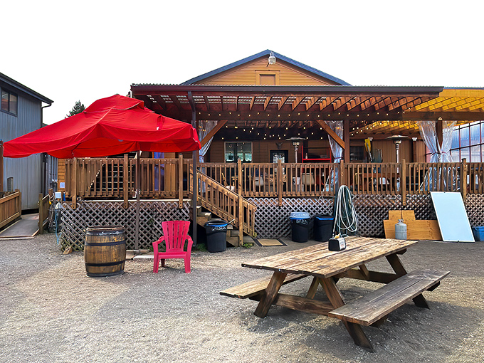 The unassuming exterior of Riverside Fish n' Chips beckons with its rustic charm, red umbrella, and promise of seafood treasures waiting to be discovered.