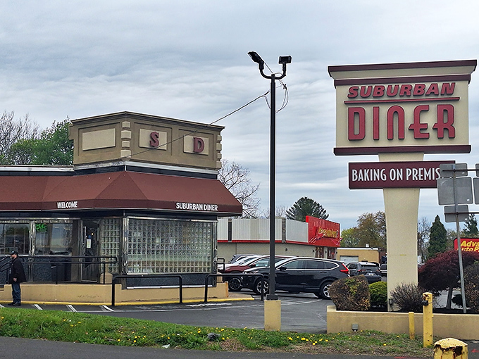 The iconic Suburban Diner sign stands proud along Bustleton Pike, promising "BAKING ON PREMISES" – a siren song for carb enthusiasts everywhere.