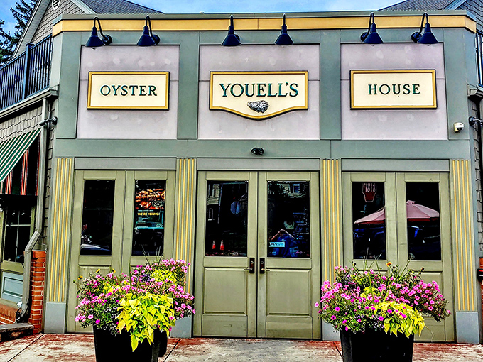 The sage-green façade of Youell's Oyster House welcomes seafood lovers with its elegant signage and vibrant flower boxes—a maritime oasis in downtown Allentown.