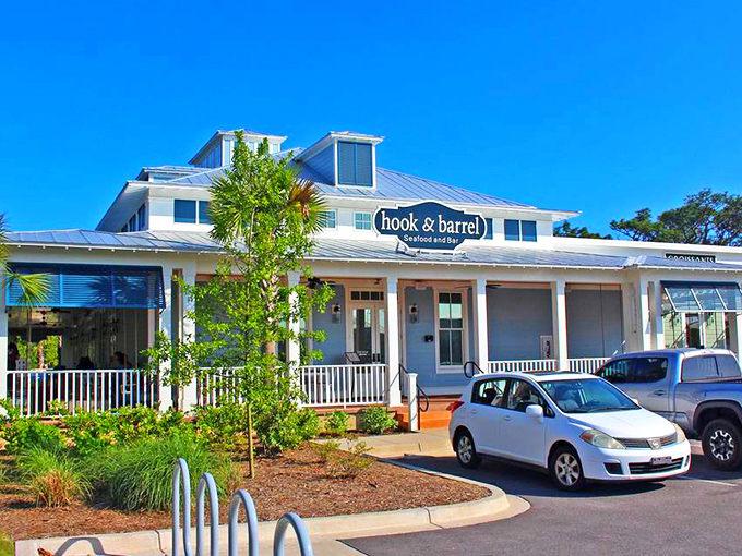 The coastal charm hits you before the first bite. Hook & Barrel's white clapboard exterior and welcoming porch practically whisper "seafood paradise awaits."