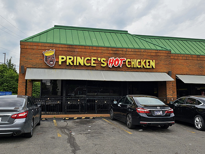 The unassuming brick exterior of Prince's Hot Chicken South belies the flavor inferno waiting inside. That green roof? Nature's warning sign.