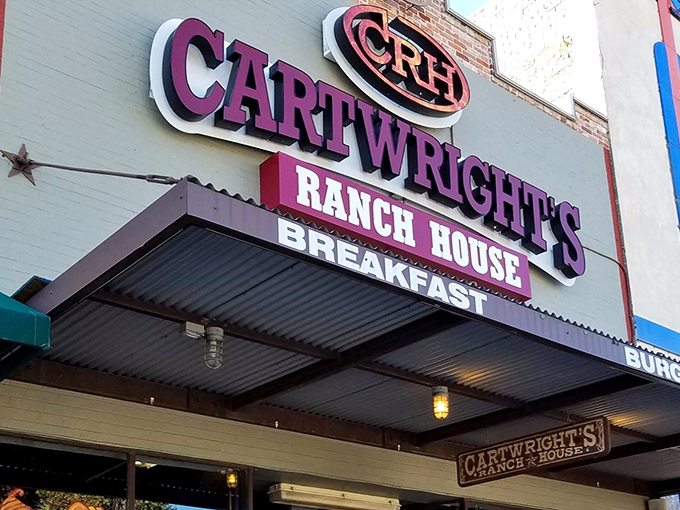 The purple sign beckons like a Texas-sized promise &ndash; Cartwright's Ranch House isn't just a restaurant, it's a declaration of comfort food devotion.