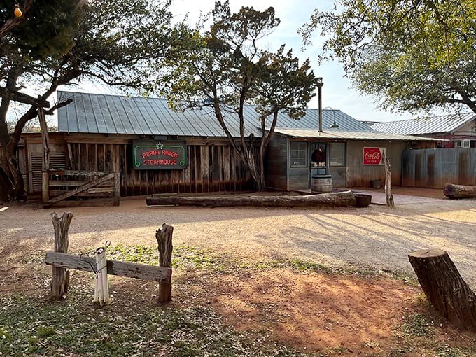 The unassuming exterior of Perini Ranch Steakhouse proves once again that in Texas, the most spectacular food often hides behind the most modest facades.