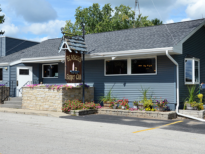 Blue-sided and unassuming, Blanck's Supper Club stands like a culinary lighthouse in Malone, beckoning hungry travelers with colorful flower boxes and the promise of Wisconsin hospitality.