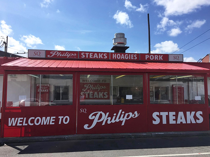 The iconic red exterior of Philip's Steaks stands out like a beacon of hope for the hungry. Philadelphia's sandwich shrine awaits.