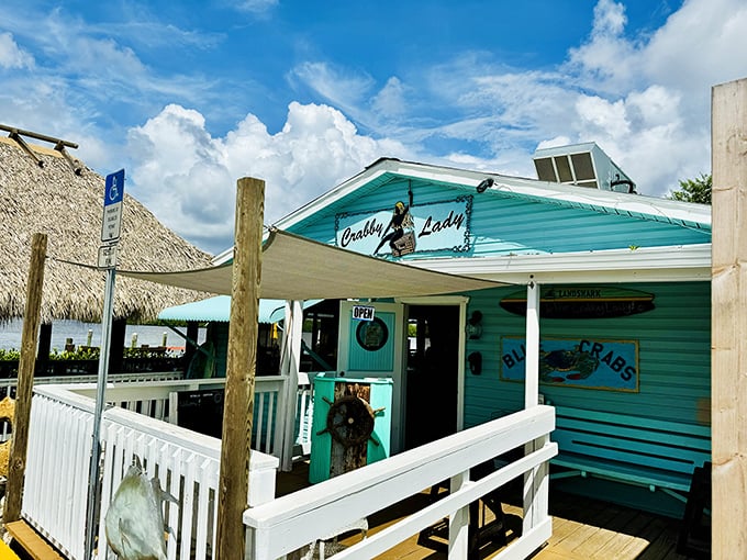 The turquoise beacon of seafood paradise! Crabby Lady's charming exterior promises Florida authenticity with every weathered board and welcoming ramp.