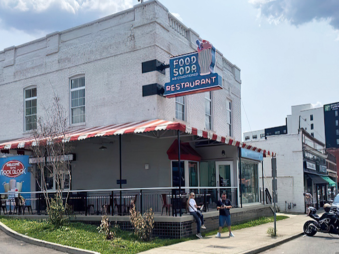 The iconic white brick building with its vintage "FOOD SODA" neon sign stands as Nashville's time machine to simpler days, complete with classic red and white awning.