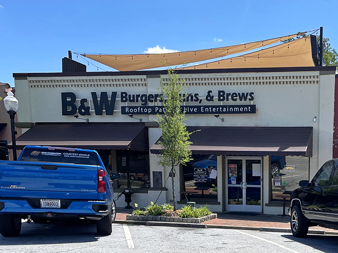 The unassuming exterior of B&W Burgers, Buns, & Brews in Norcross hides culinary treasures that would make any food detective proud.