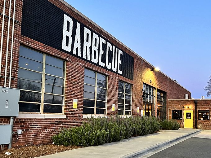 The bold "BARBECUE" declaration on this brick fortress isn't just signage&mdash;it's a promise that's kept with every smoky bite inside.