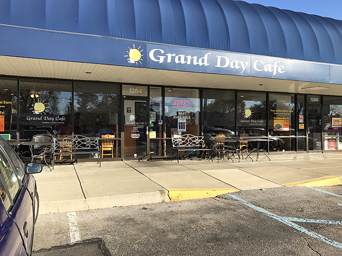 The classic blue awning of Grand Day Cafe stands as a beacon of breakfast hope in this Columbus strip mall—proof that culinary treasures often hide in plain sight.