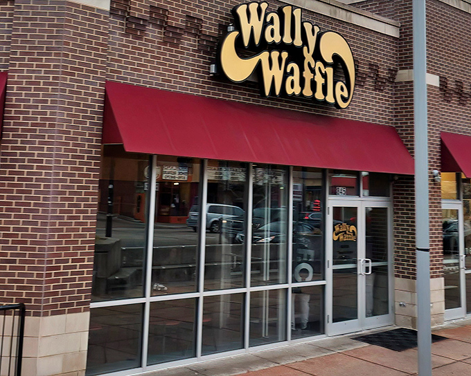 The iconic yellow Wally Waffle sign beckons breakfast enthusiasts like a lighthouse guiding hungry sailors to the shores of deliciousness