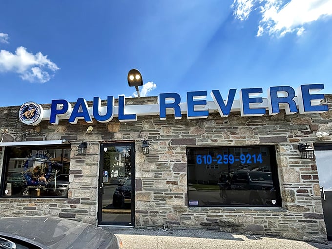 The stone exterior of Paul Revere Pizza House stands like a culinary fortress, its blue sign a beacon for those seeking Pennsylvania's finest pizza cheesesteaks.