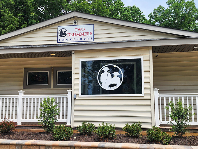 The yellow facade of Two Drummers Smokehouse welcomes hungry travelers like a beacon of barbecue hope on Virginia's culinary landscape.