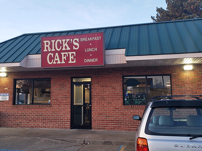 The unassuming brick exterior with its distinctive green roof and bold red sign promises what every great local spot should: no pretense, just honest-to-goodness deliciousness waiting inside.