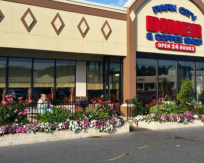 The welcoming facade of Park City Diner stands as a 24-hour beacon for hungry travelers, its flower boxes adding a touch of homey charm to this Lancaster institution.