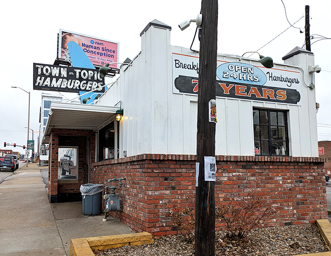 The iconic white brick building with its vintage signage stands as a time capsule of American diner culture, beckoning hungry travelers 24 hours a day.
