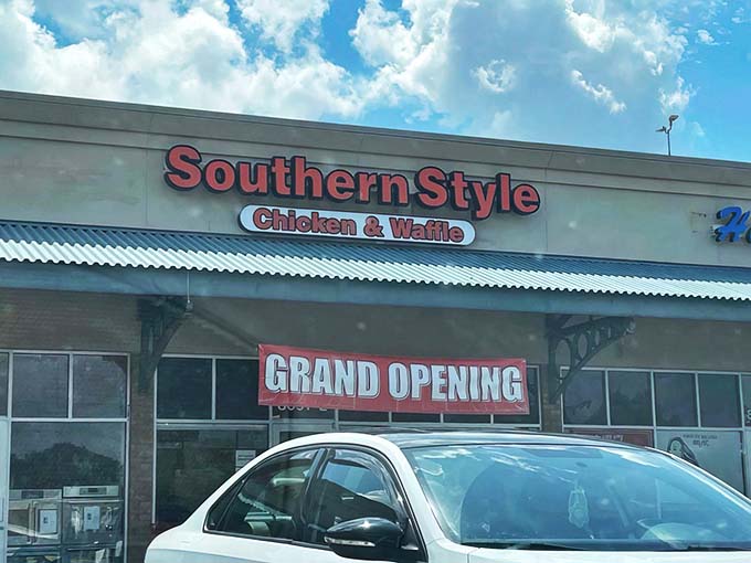 The bright red signage of Southern Style Chicken & Waffle beckons like a lighthouse to hungry souls navigating the sea of strip mall sameness.