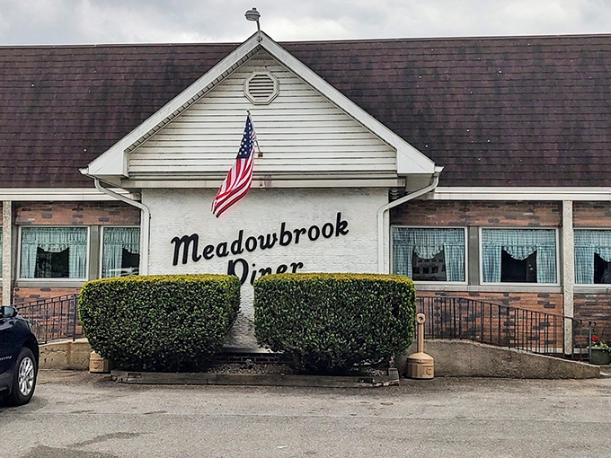 The classic American flag above Meadowbrook Diner isn't just decoration&mdash;it's a promise that inside awaits the kind of breakfast that made this country great.