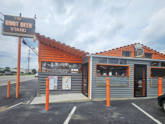 The iconic orange-and-brown exterior of The Root Beer Stand beckons like a time machine disguised as a roadside eatery. Nostalgia never tasted so good.
