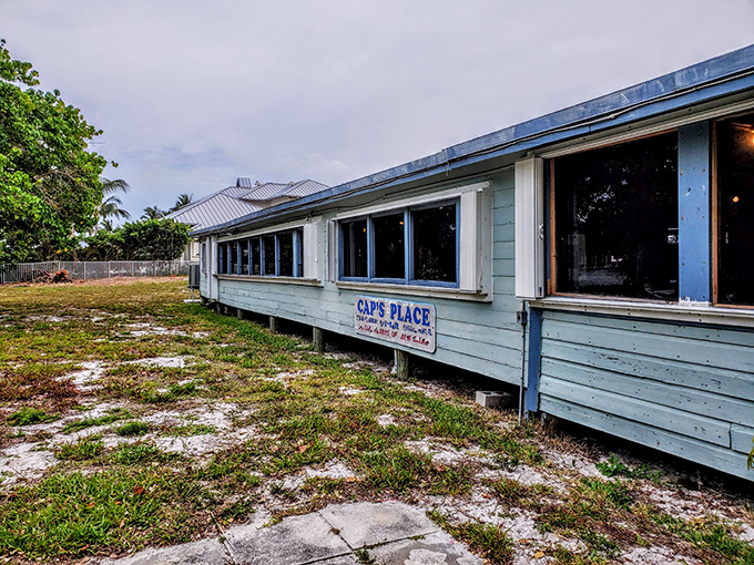 The weathered blue exterior of Cap's Place stands as a defiant time capsule on Florida's coast, promising seafood adventures that Instagram filters can't replicate. 