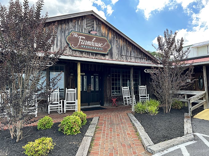 The rustic wooden exterior of The Farmhouse beckons with white rocking chairs and a brick pathway that practically whispers, "Slow down and stay awhile."