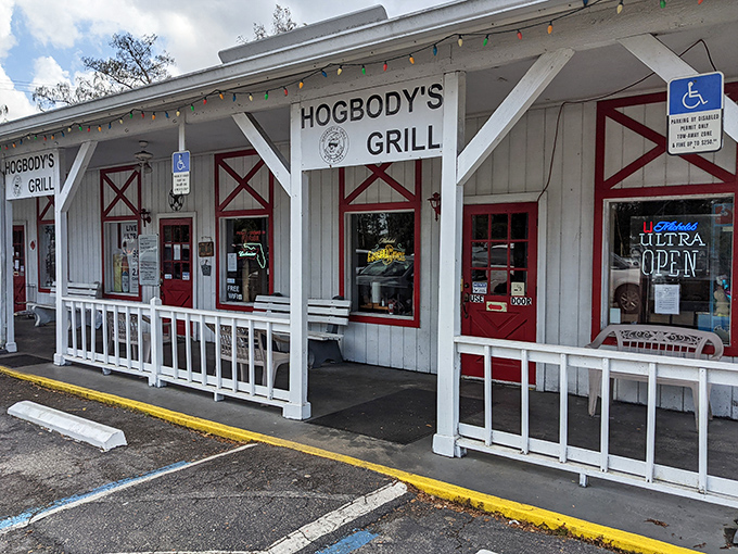 The barn-inspired exterior of Hogbody's, with its distinctive red doors and white clapboard, promises authentic flavors hiding behind that unassuming fa&ccedil;ade.