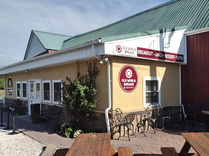 This charming yellow building with its green roof practically whispers "homemade goodness" from every weathered board.