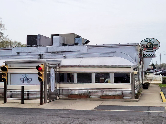 This gleaming silver beauty sits like a chrome-plated promise of breakfast perfection on Main Street.