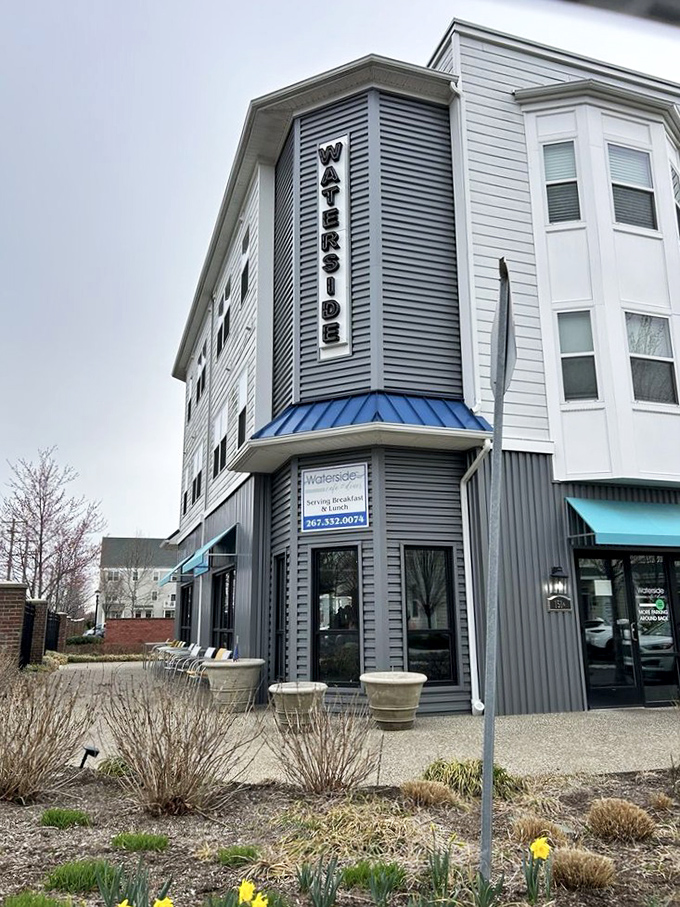 Modern meets cozy at this corner establishment, where the teal awnings and flower pots hint at the warm welcome waiting inside.
