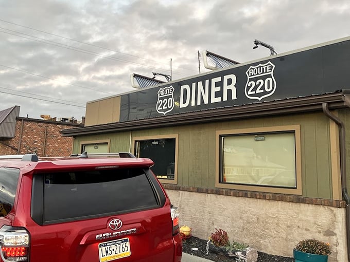 The unassuming exterior of Route 220 Diner stands like a culinary lighthouse for hungry travelers &ndash; no fancy frills, just the promise of honest food inside.
