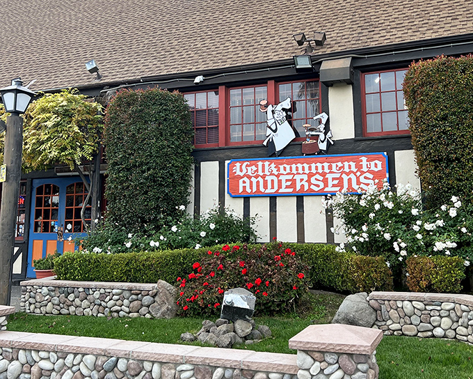 The iconic Tudor-style exterior of Pea Soup Andersen's welcomes road-weary travelers with its charming "Velkommen" sign and those famous cartoon pea-splitting mascots.